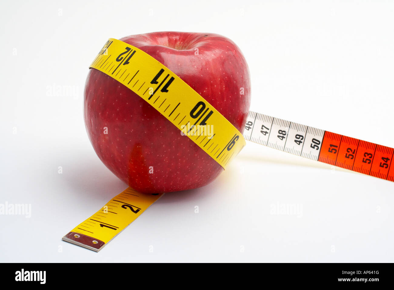 Red Apple with tape measure on white background Stock Photo - Alamy
