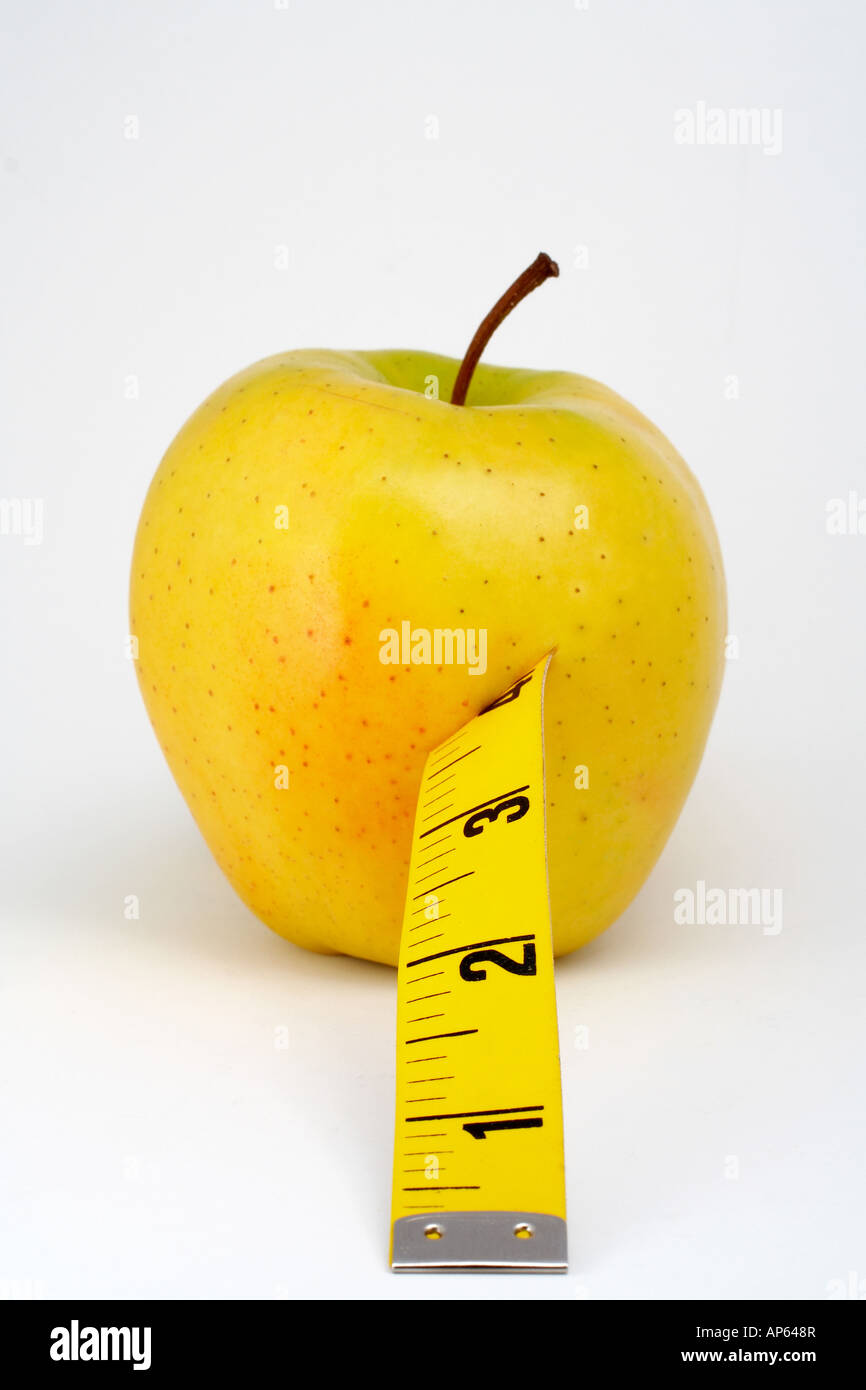 Apple with tape measure on white background Stock Photo - Alamy