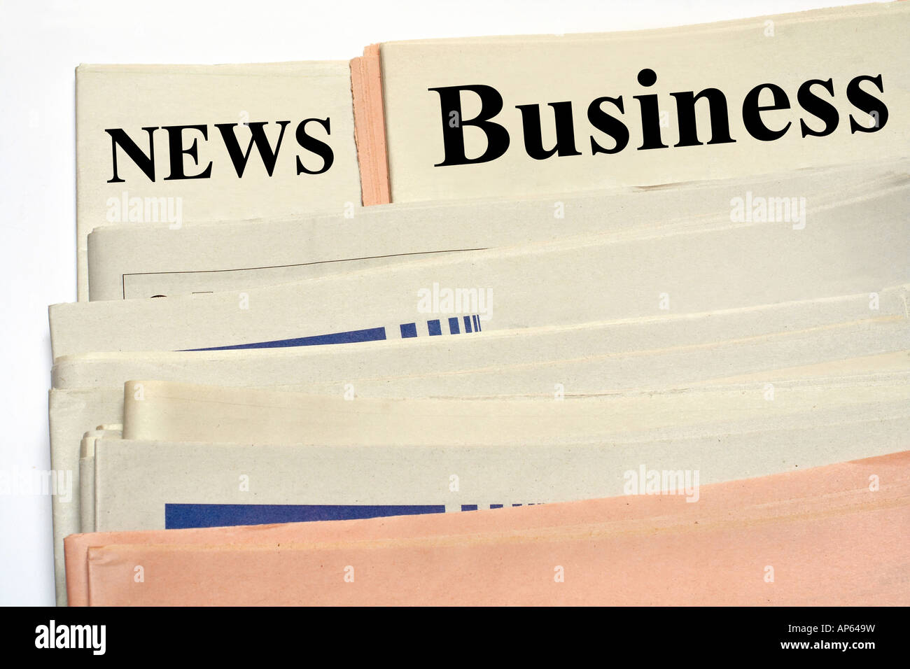 Stacked business newspapers on white background Stock Photo - Alamy