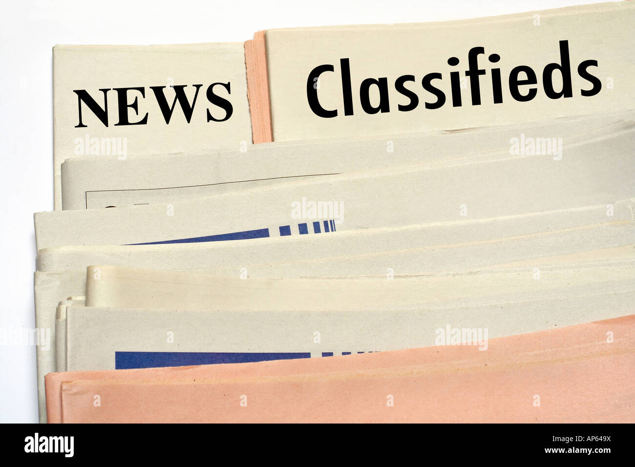Stacked classifieds newspapers on white background Stock Photo - Alamy