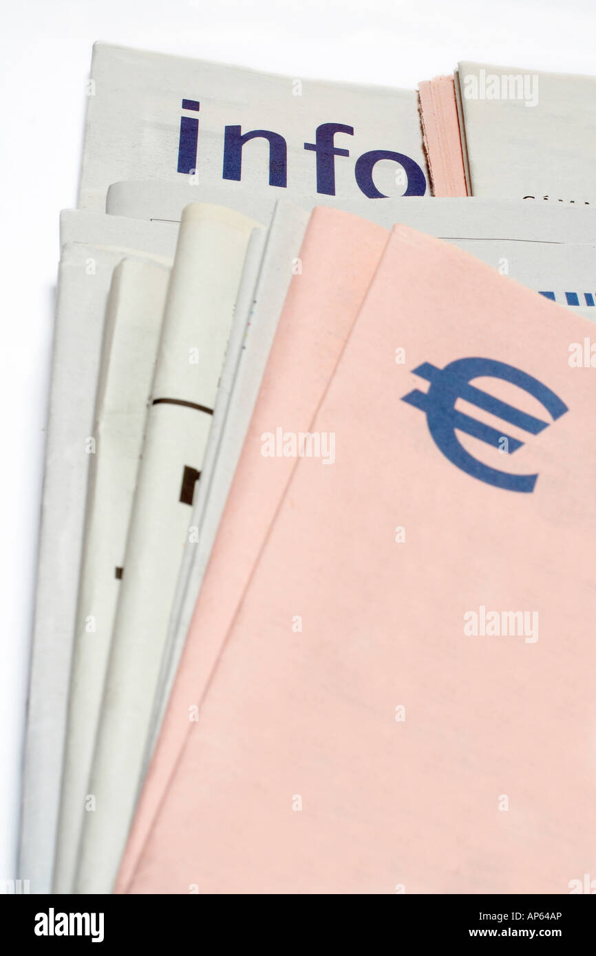 Euro symbol on Stacked newspapers a white background Stock Photo - Alamy