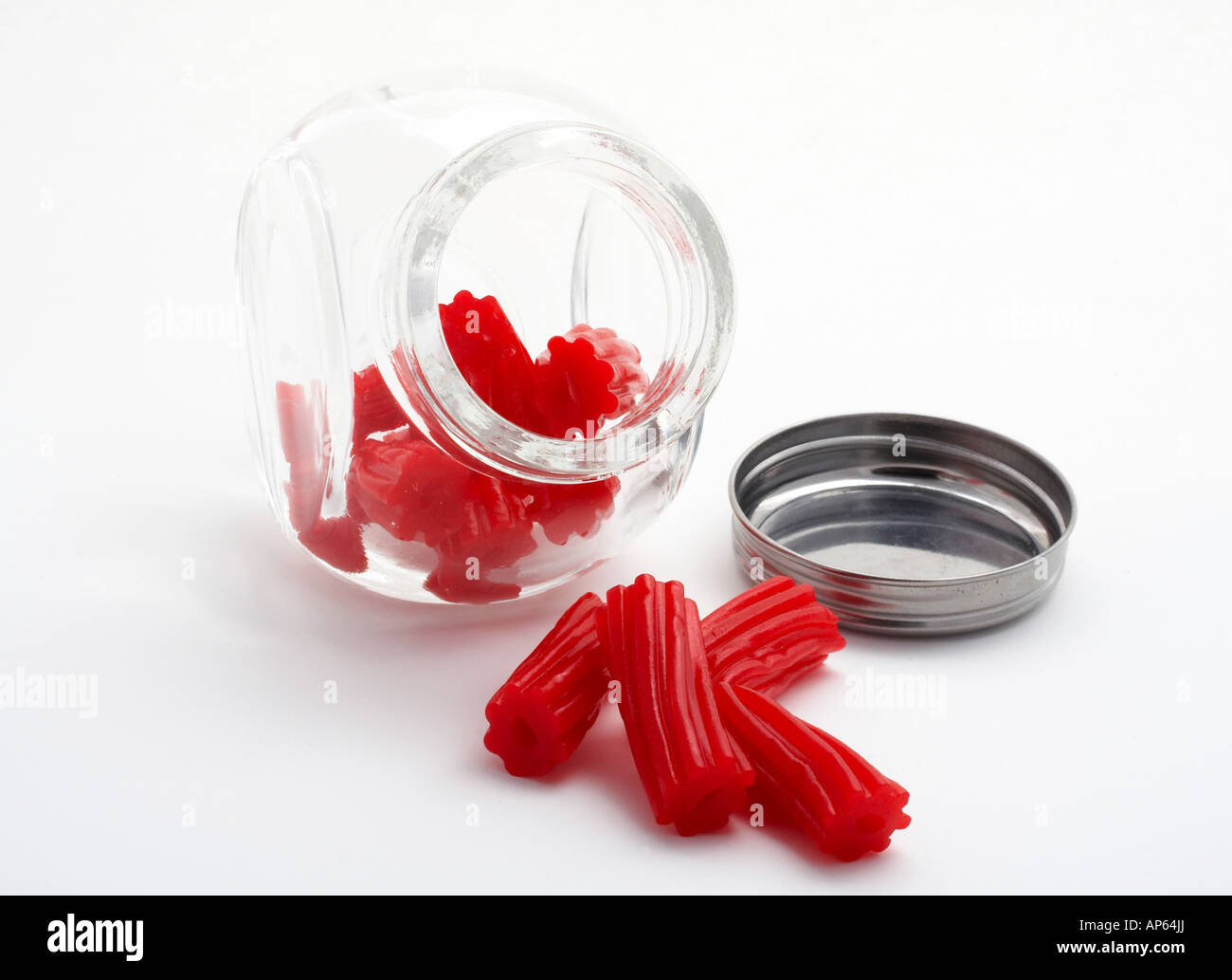 Pieces of red licorice on glass jar Isolated on white background Stock ...