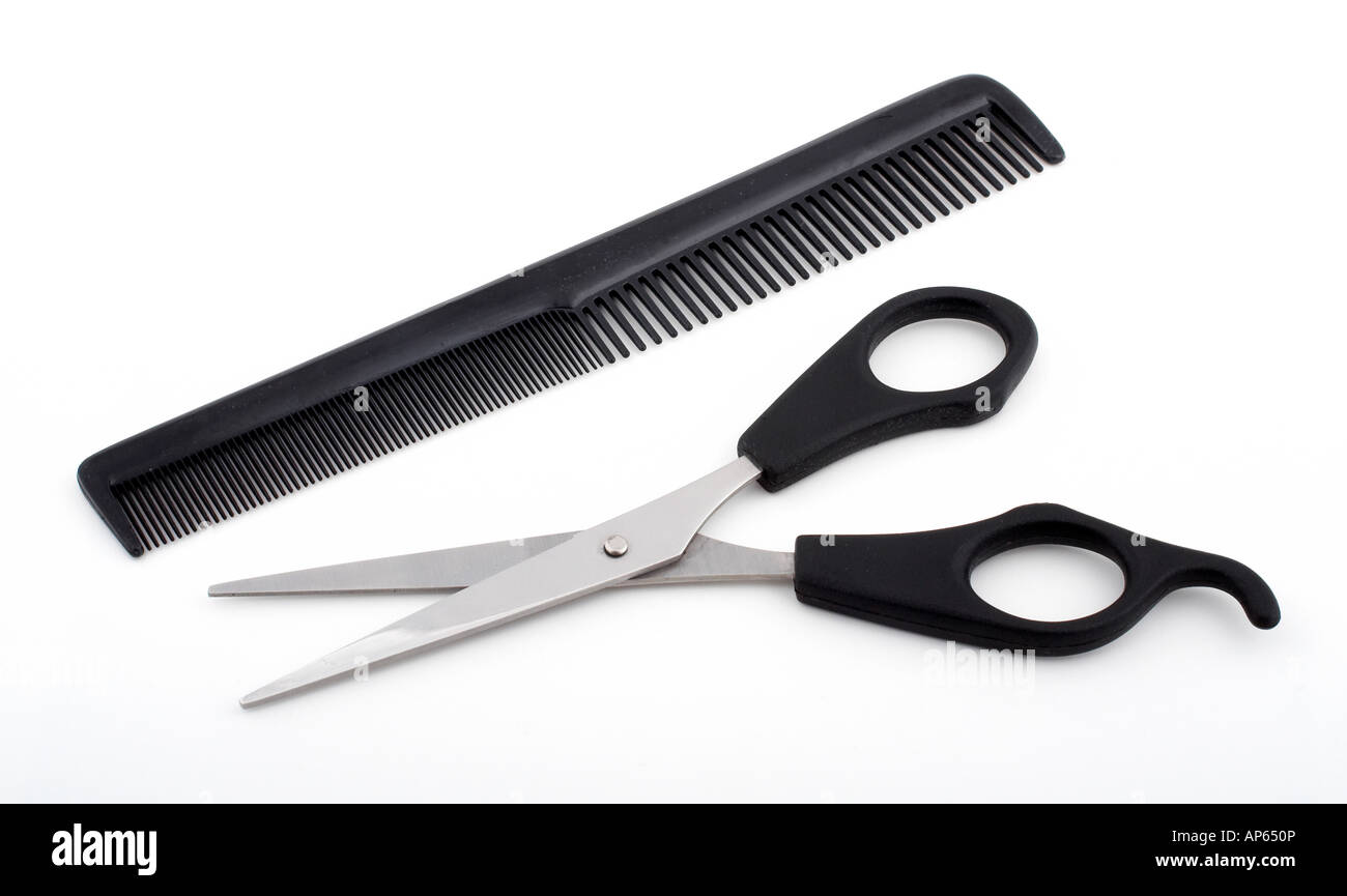 Scissors and comb isolated on white background Stock Photo - Alamy