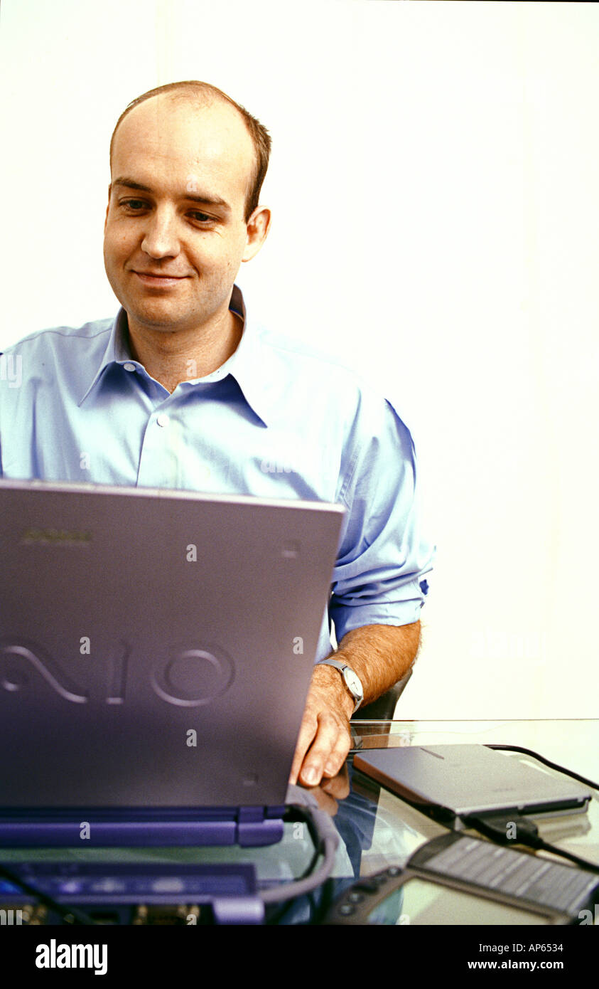 Office worker with laptop computer Stock Photo - Alamy