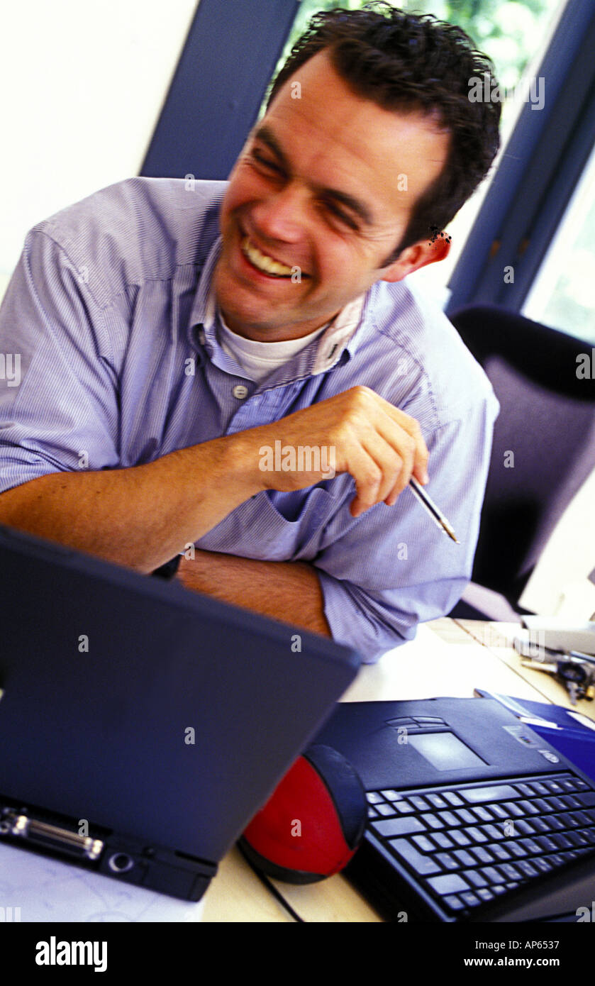 Office worker with laptop computer Stock Photo - Alamy