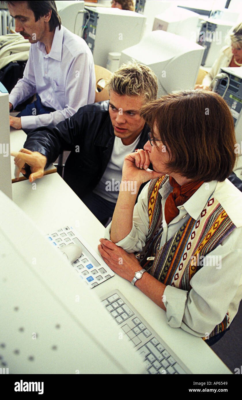 Adult education computer lesson Young persons teach older men and women ...