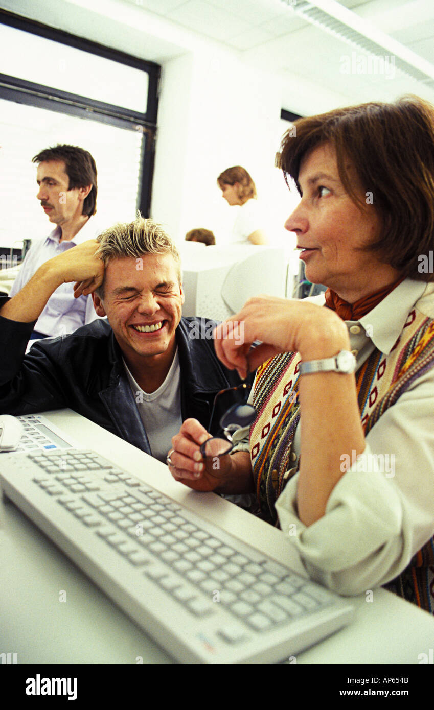 Adult education computer lesson Young persons teach older men and women ...