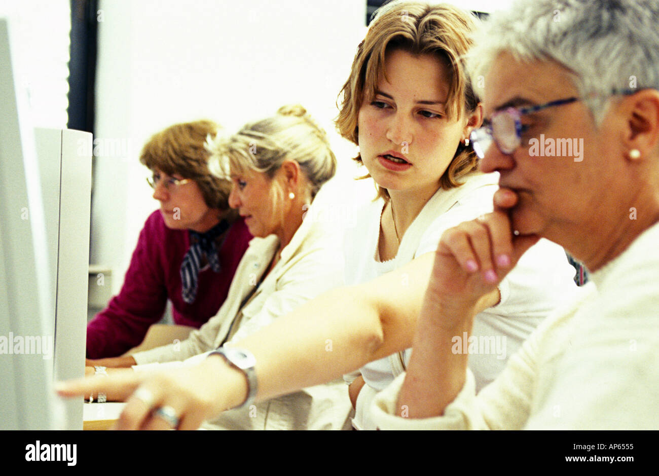 Adult education computer lesson Young persons teach older men and women ...