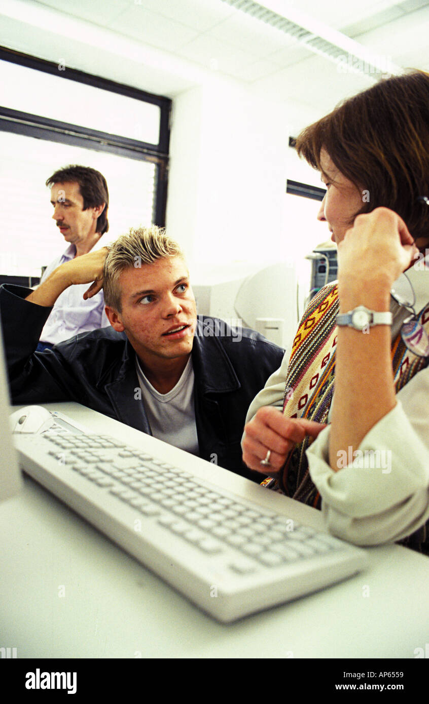 Adult education computer lesson Young persons teach older men and women ...