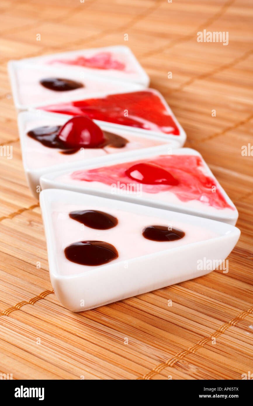 Desserts creamy on the white triangles in bamboo mat Stock Photo - Alamy