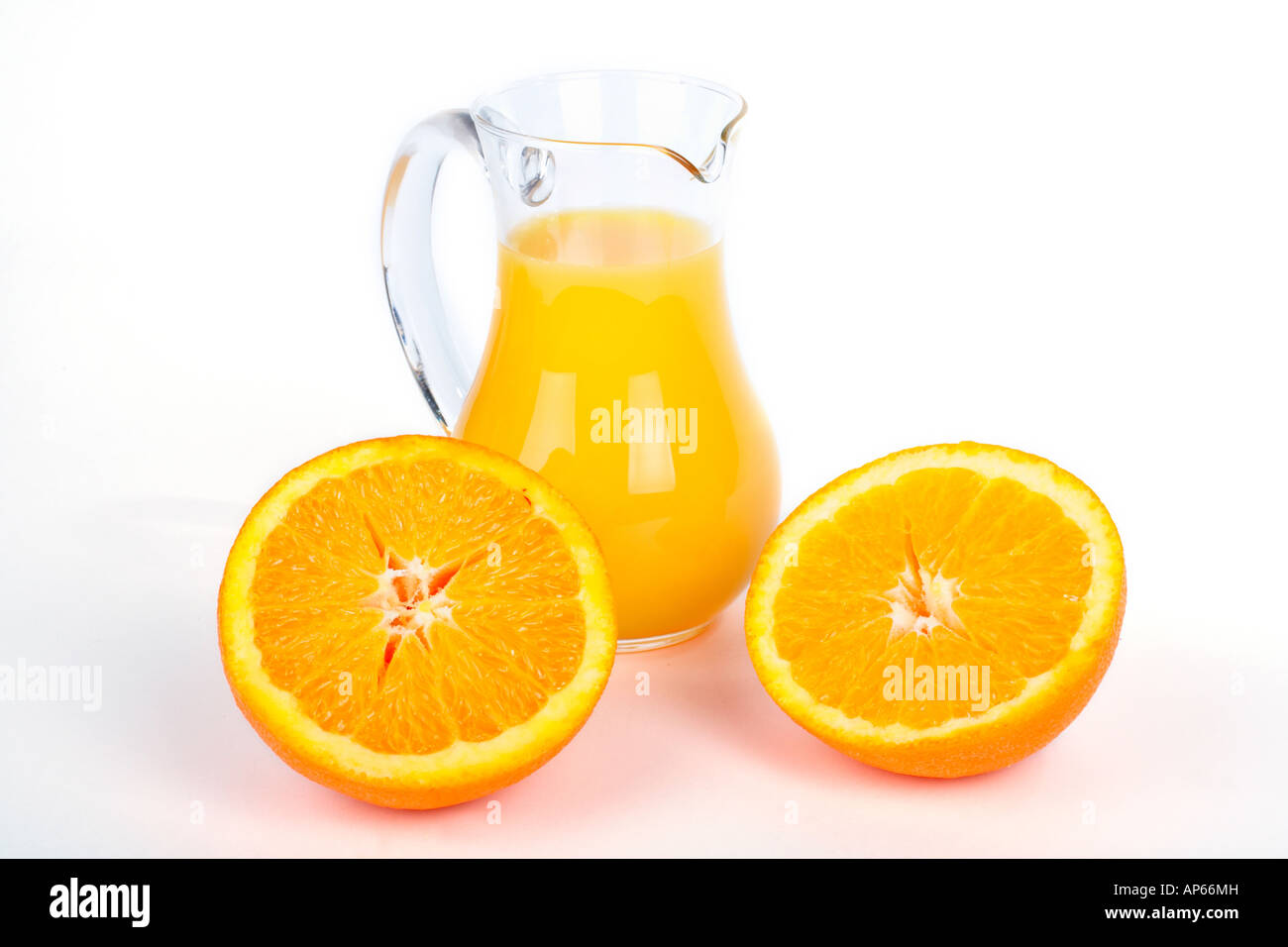 Orange juice jug and 2 halves of orange Stock Photo - Alamy