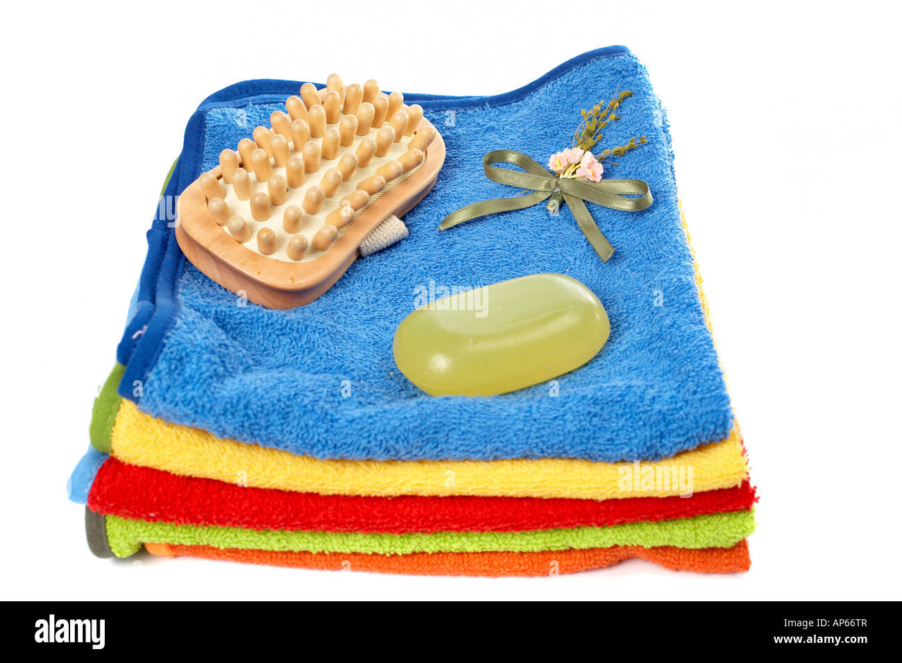 Brush and tablet of soap on the multicolour towels stacked Stock Photo ...
