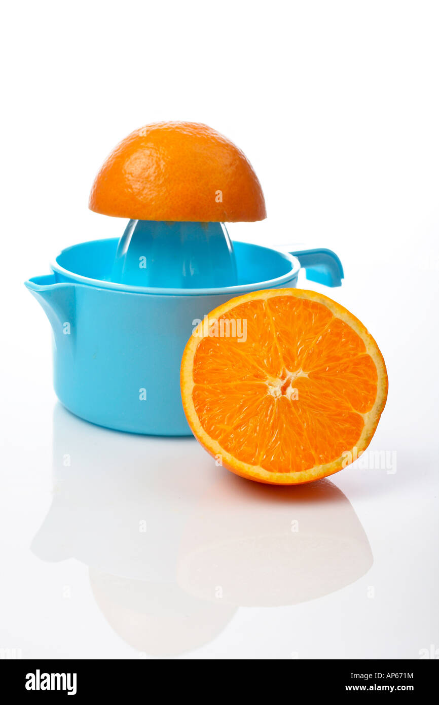 Squeezer and two half orange reflected on white background Stock Photo ...