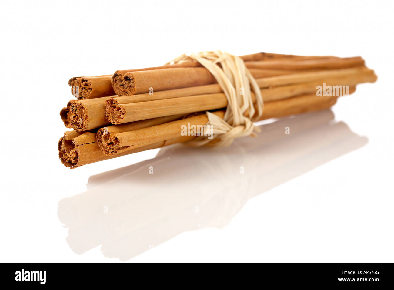 Sticks of cinnamon joined with string on the white background Shallow ...