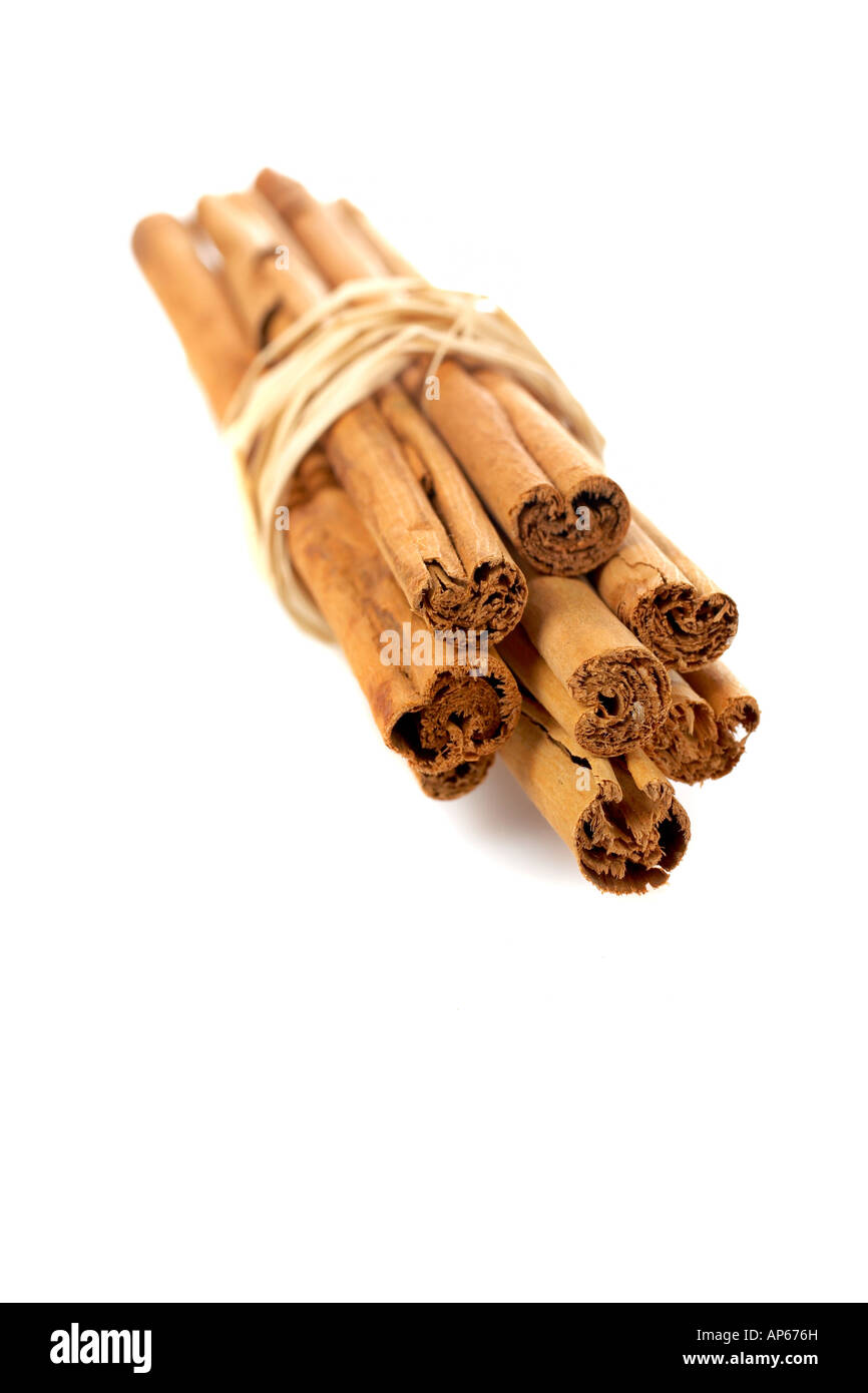 Sticks of cinnamon joined with string on the white background Shallow ...