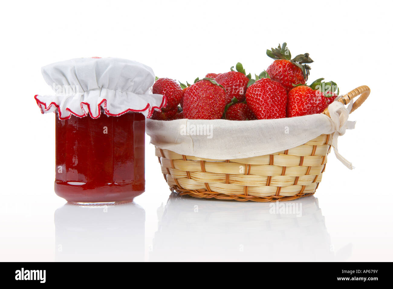 Jam jar and basket of strawberries reflected on white background Stock ...