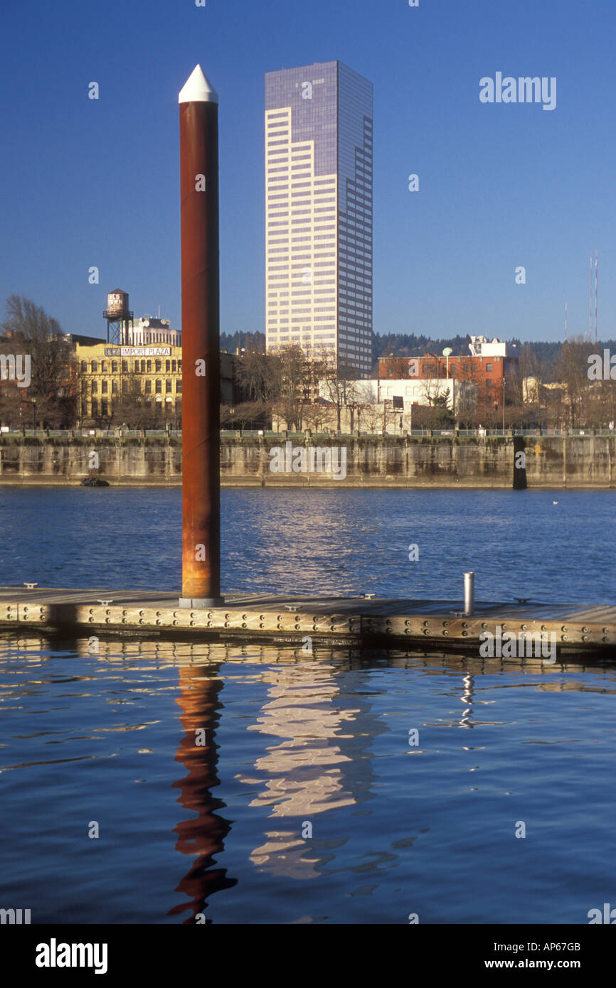 A marroon colored pylon supports a floating dock along the Willamette ...