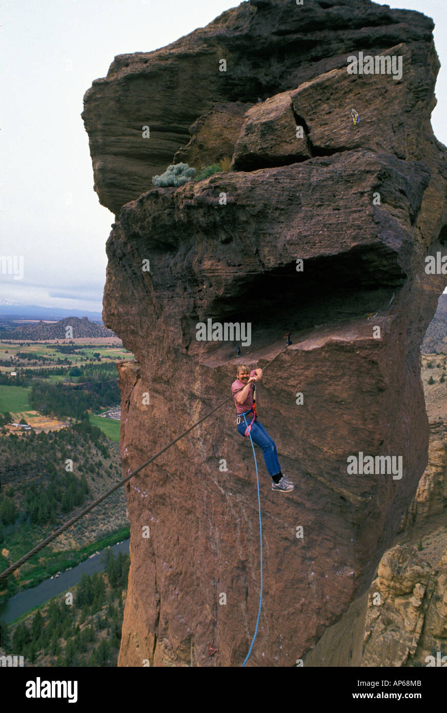 A rock climber tries to make his way across a wire at Monkey face, in ...