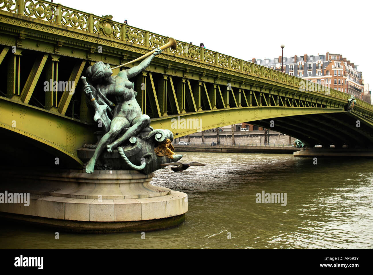 A statue of a woman playing a trumpet adorns a bridge in Paris Stock ...