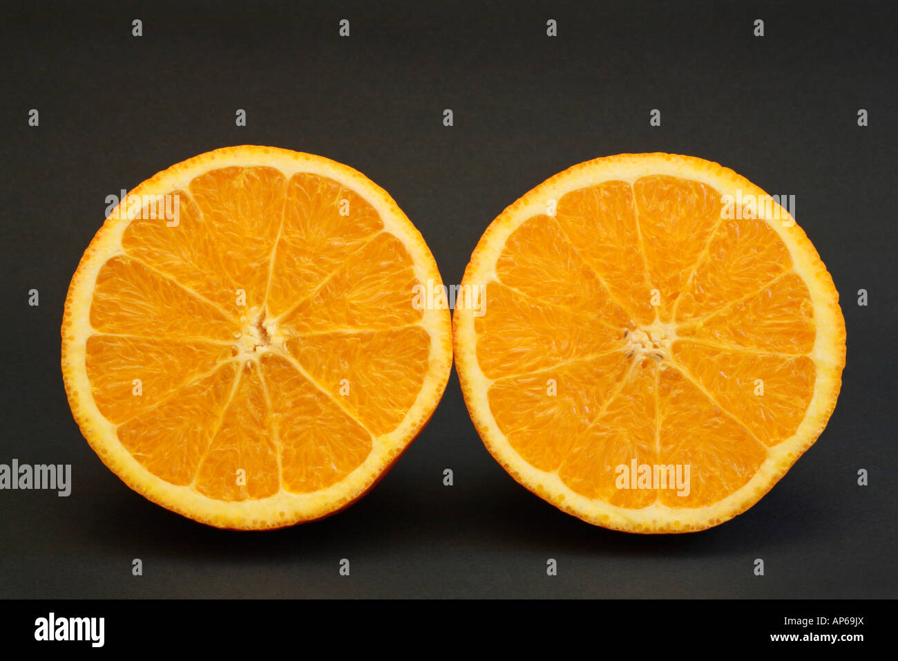 Close up of an orange sliced in half Stock Photo - Alamy