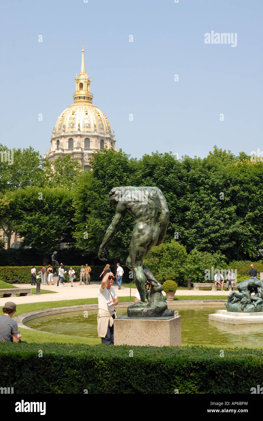 A tourist looking at a Rodin sculpture in the garden of the Rodin ...