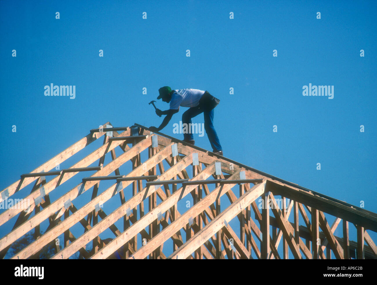 man working on roof construction Stock Photo - Alamy