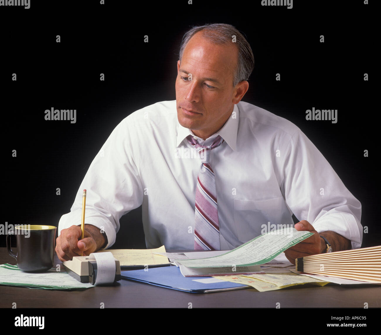 man paying bills and balancing checkbook Stock Photo - Alamy