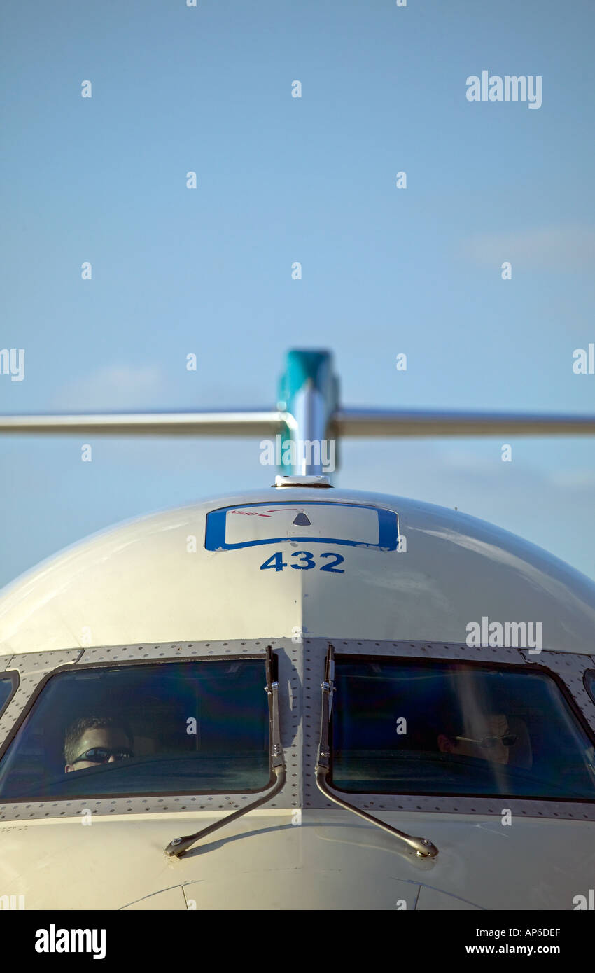 Front view of passenger jet airplane cockpit windsheild with pilots and ...