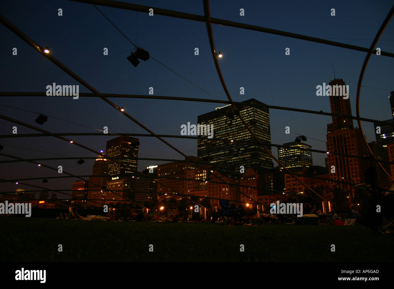 Downtown Chicago towers above the Frank Gehry Pritzker pavilion in ...