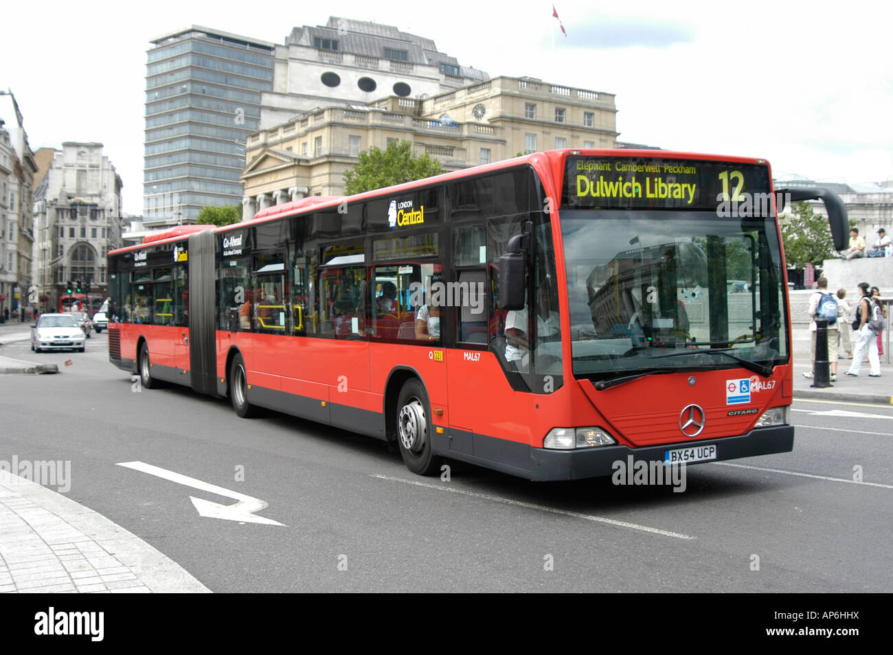 red bendy bus travelling through the city of london england Stock Photo ...