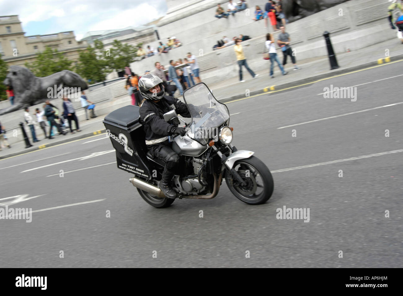 Motorcycle courier traveling in London traffic, England Stock Photo - Alamy