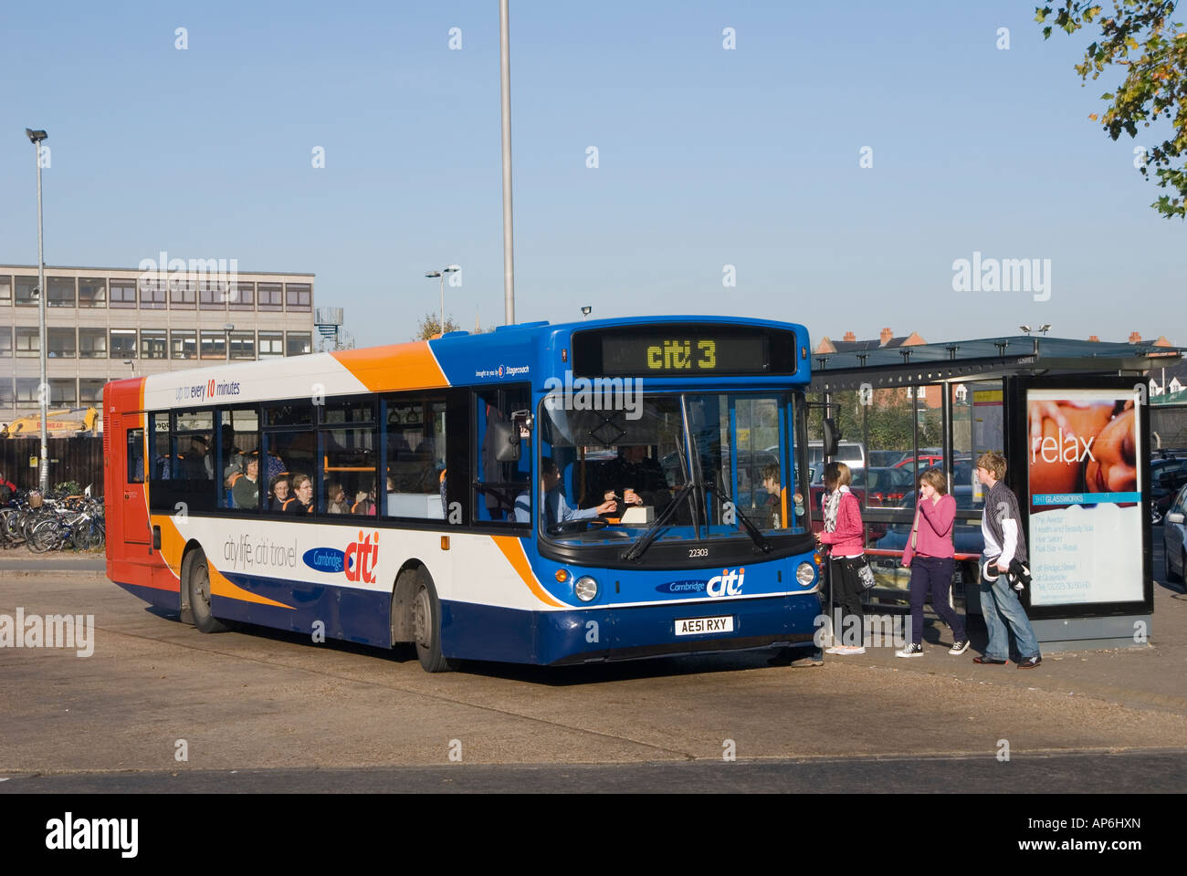 Passengers getting on to a single decker Cambridge Citi bus at a stop ...