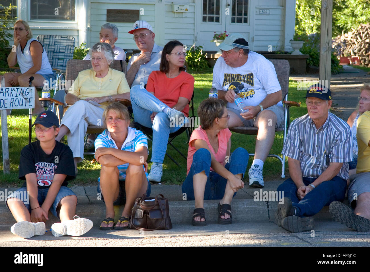Residents of Traer Iowa watch a parade for the Festival of the Spiral ...