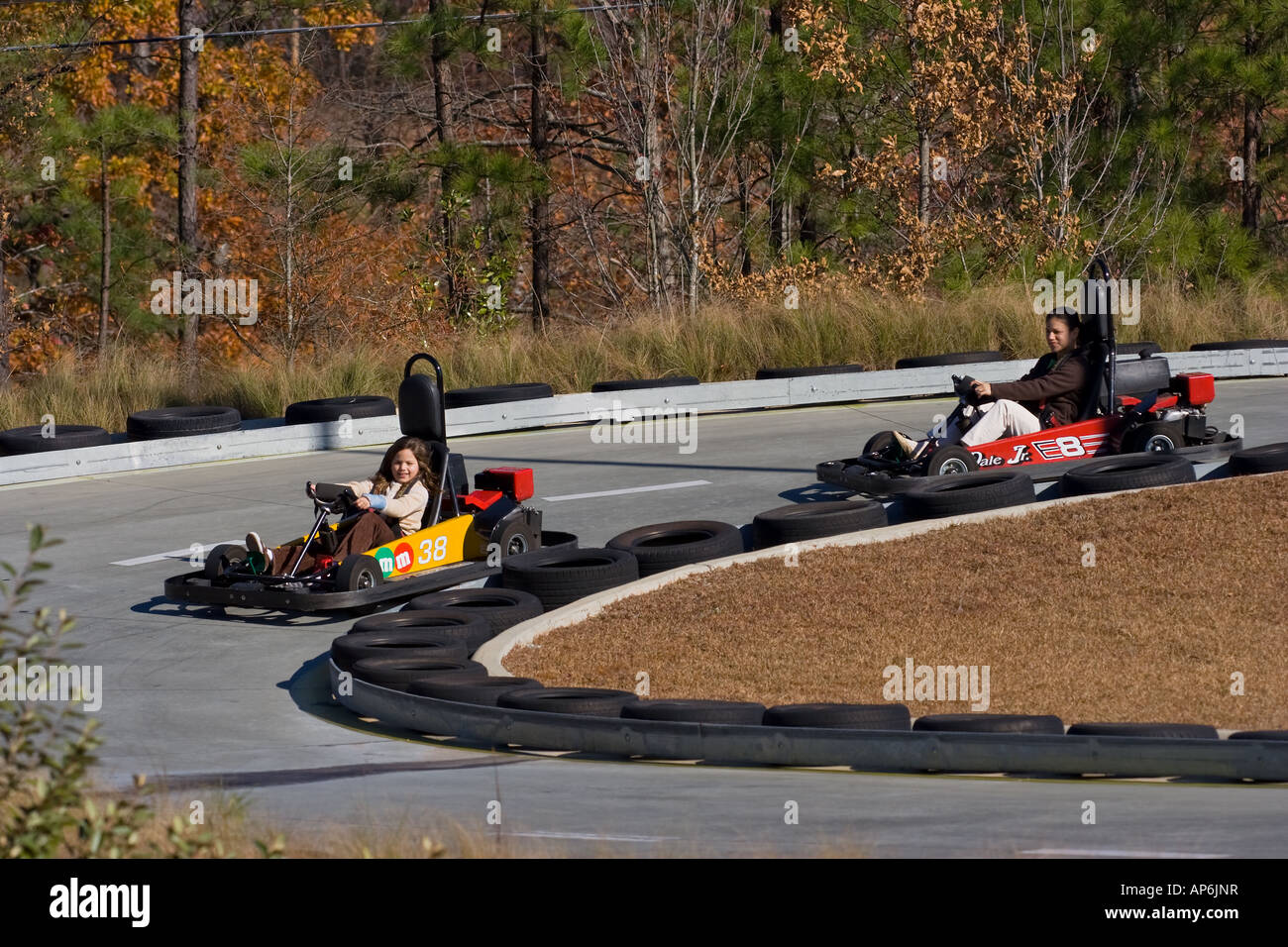 mother and daughter racing each other in go-carts around a corner Stock ...