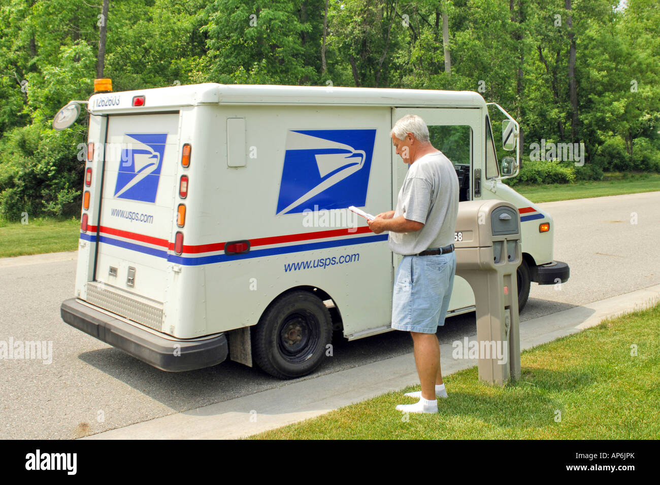 The US Mail girl delivers the mail to a waiting resident Stock Photo ...