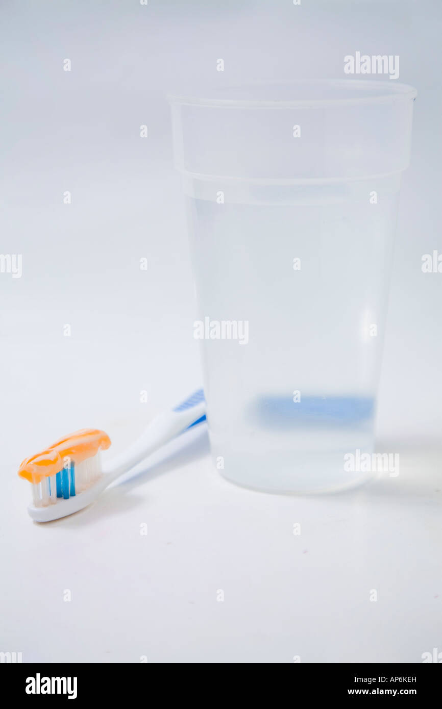 Toothbrush and cup of water Stock Photo - Alamy