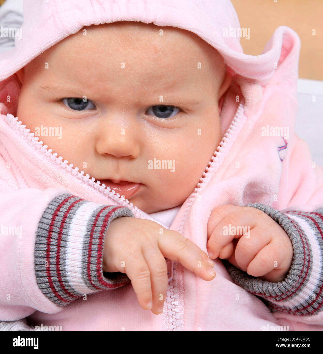portrait of a baby in an pink anorak Stock Photo - Alamy