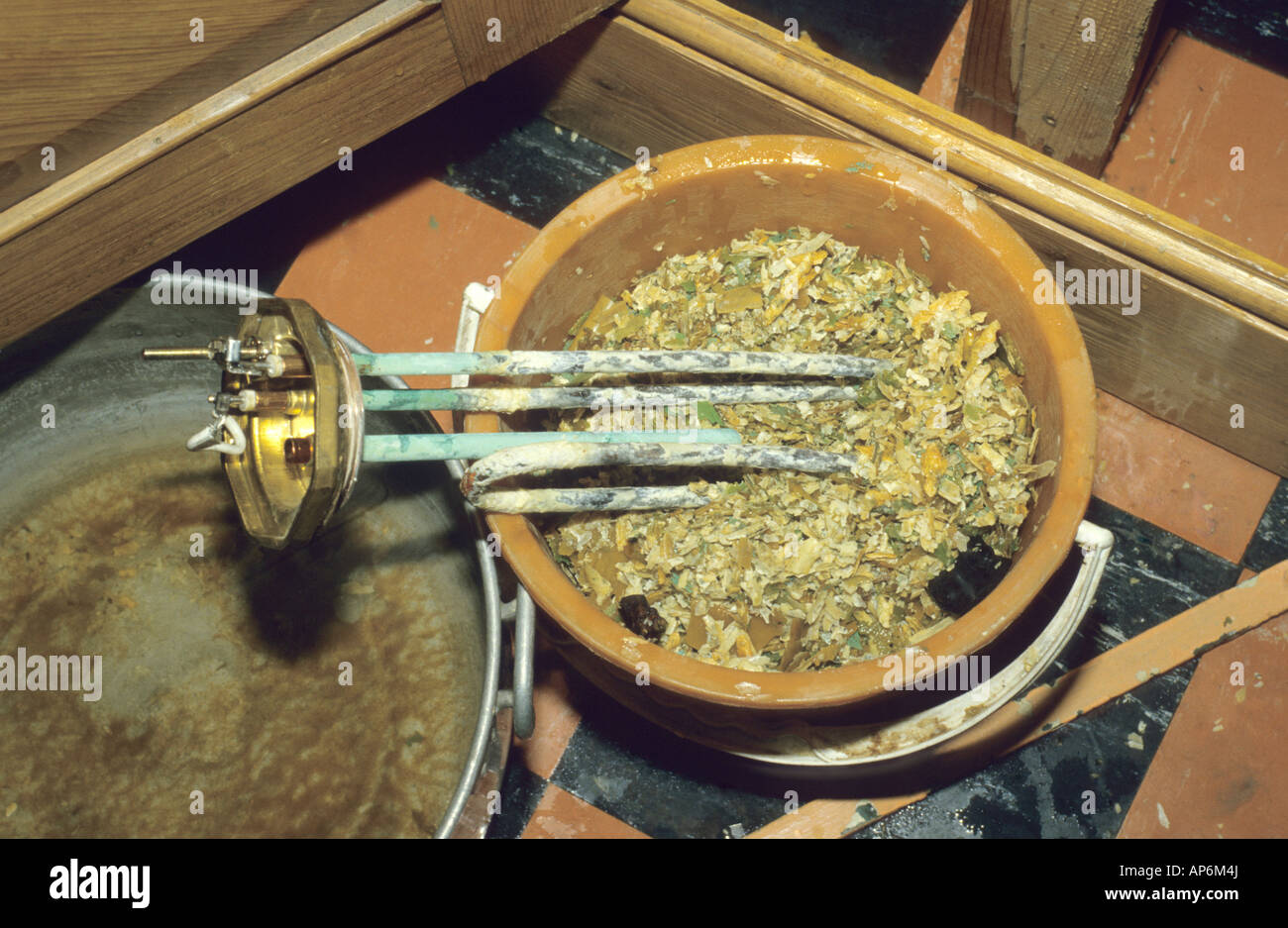 Plumber clearing calcium from hot water cistern Stock Photo - Alamy
