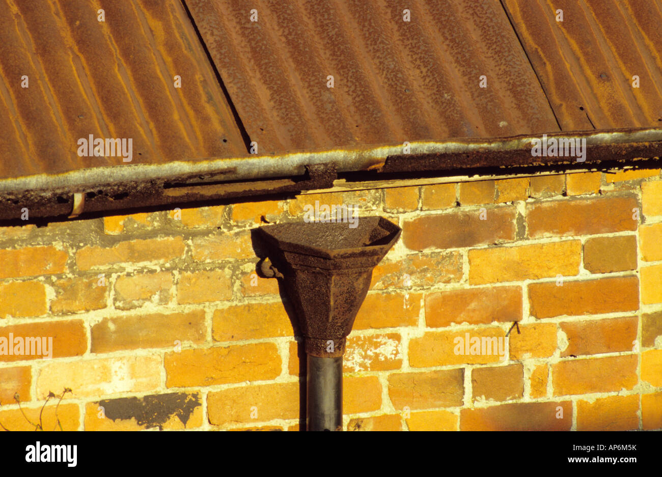 Broken, rusted rainwater gutter, hopper and drainpipe Stock Photo - Alamy