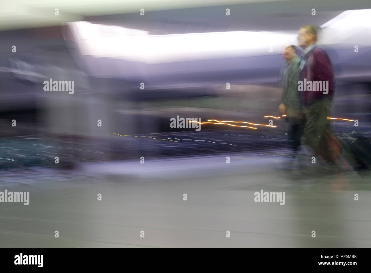 Men Rushing Fast Through Airport With Luggage Blur Stock Photo - Alamy