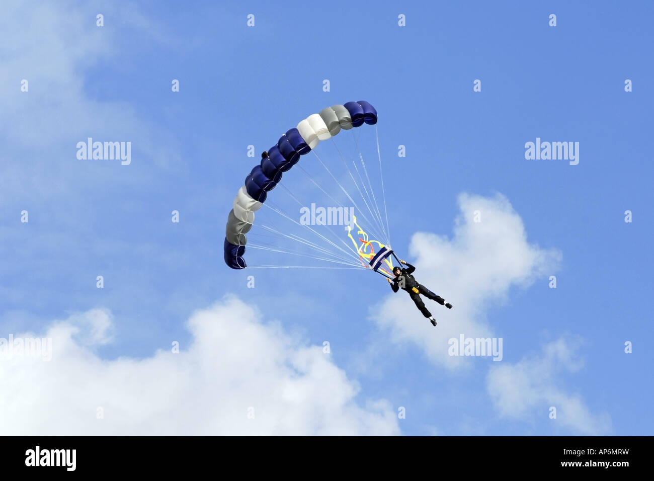 A Skydiver floats to earth using a new style rectangular parachute ...