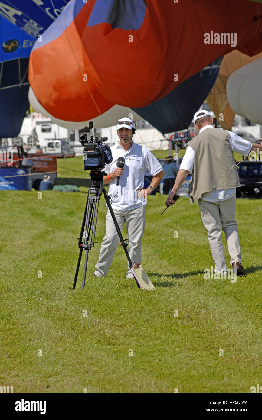 TV media cameraman and reporter at an outside broadcast summer event ...