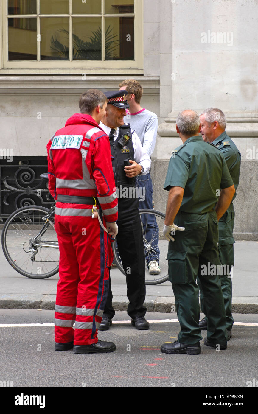 A Policeman Rapid Response doctor and paramedics discuss an emergency ...