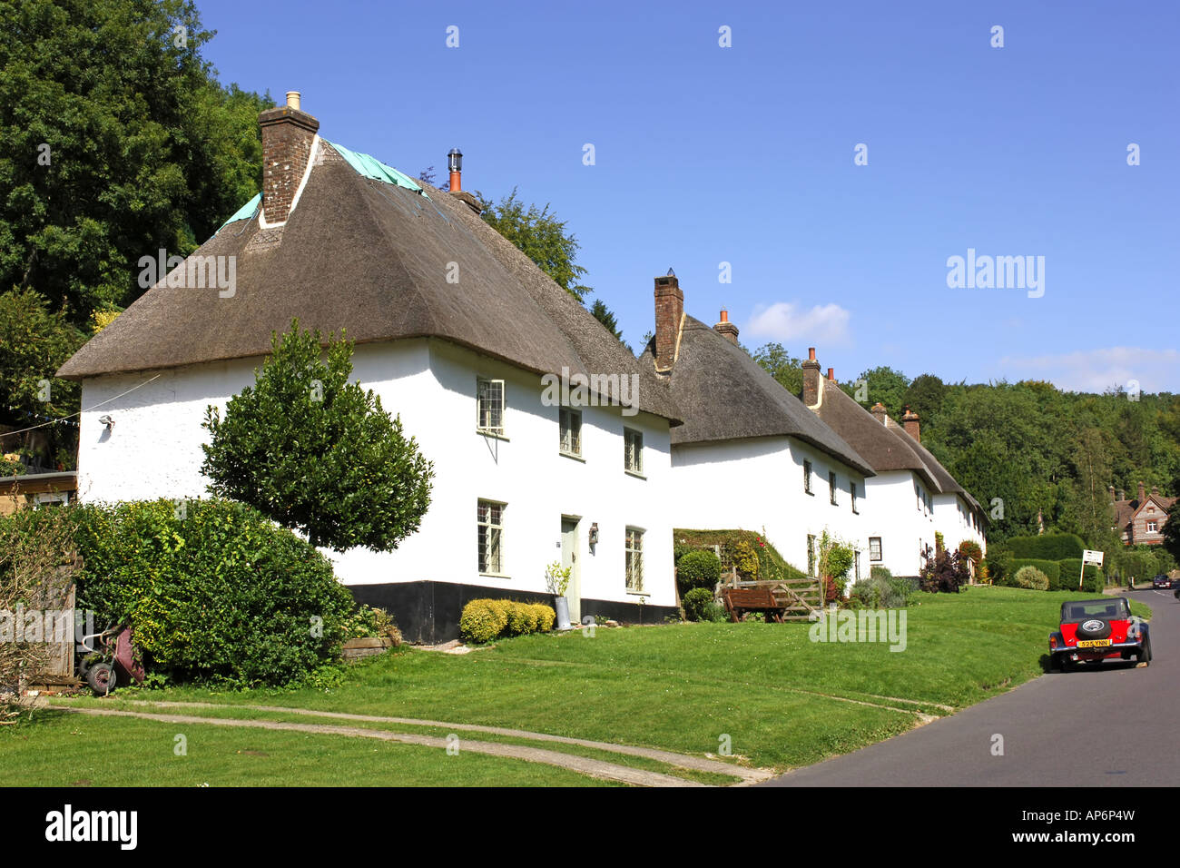 The picturesque thatched roof cottages of Milton Abbas Village Dorset ...