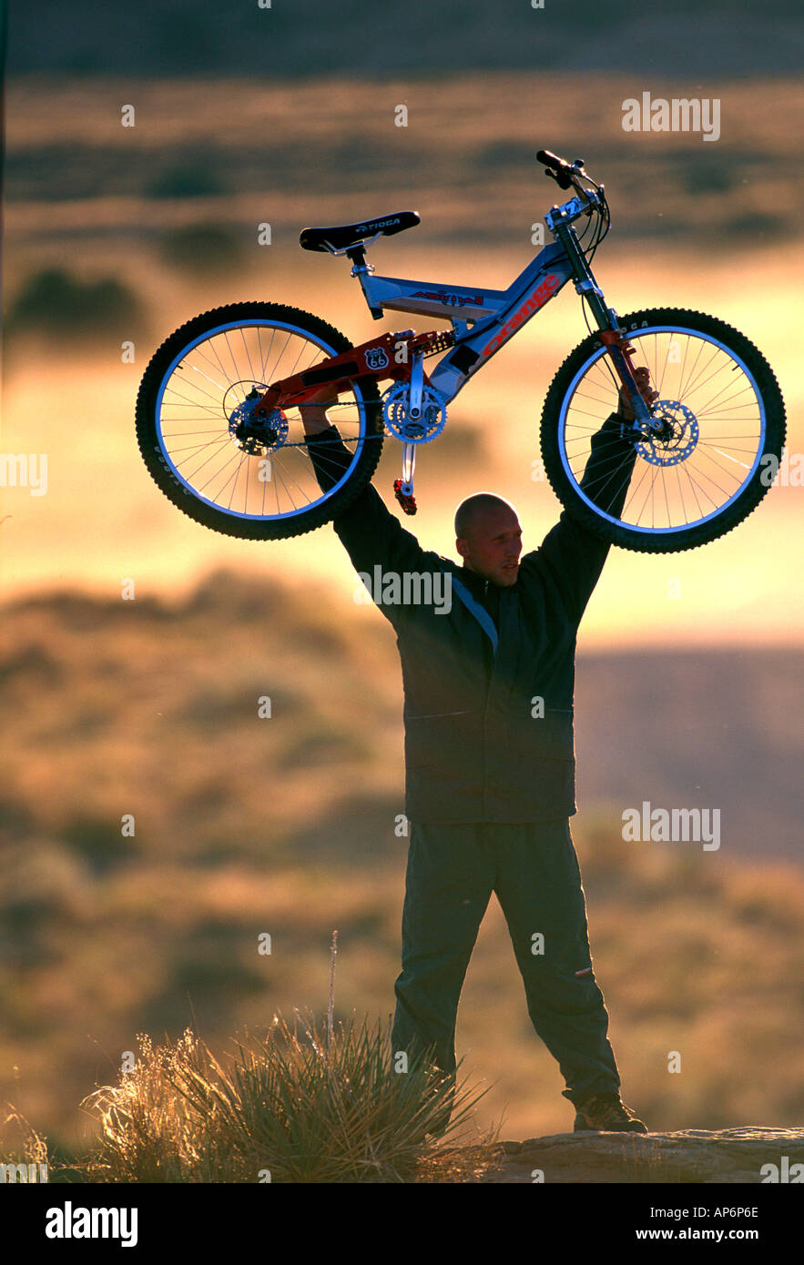 Man holding bike over head hi-res stock photography and images - Alamy