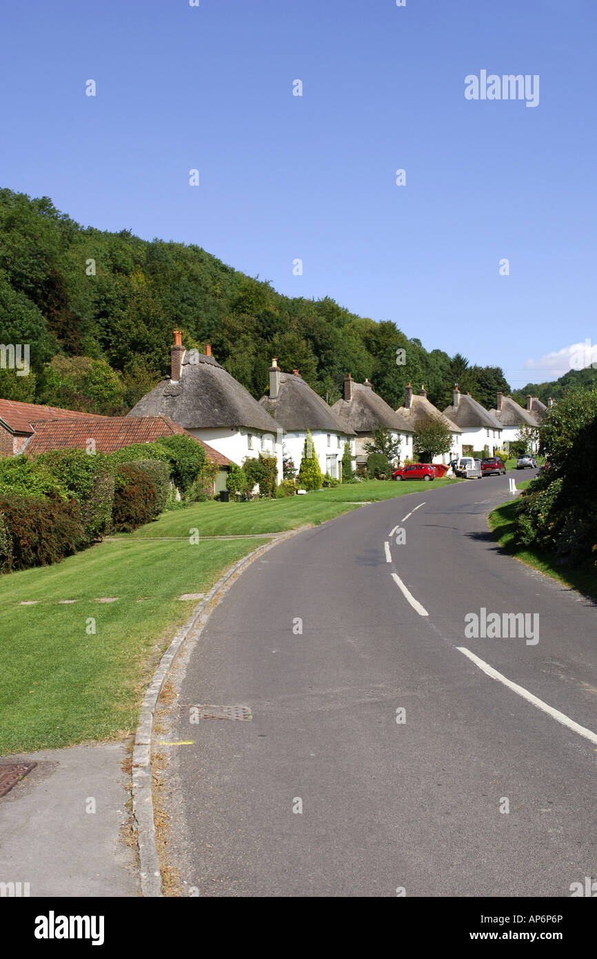 The picturesque thatched roof cottages of Milton Abbas Village Dorset ...