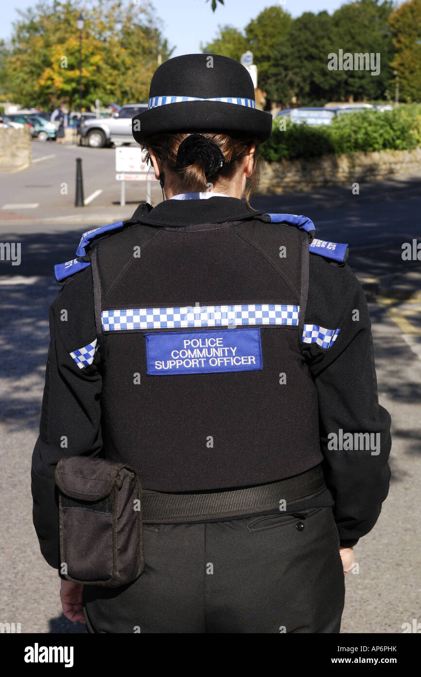 The rear view of a female English Police Community Support Officer ...