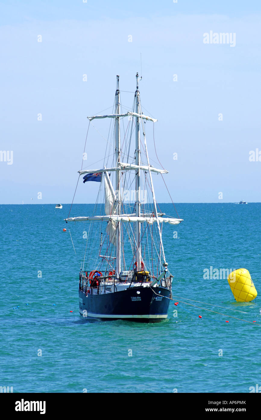 Small twin masted sail boat in Weymouth bay Stock Photo - Alamy