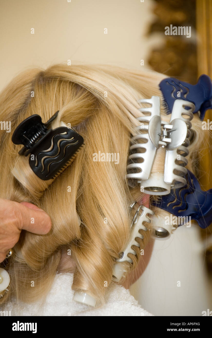 Close up of hair in curlers in front of mirror Stock Photo - Alamy