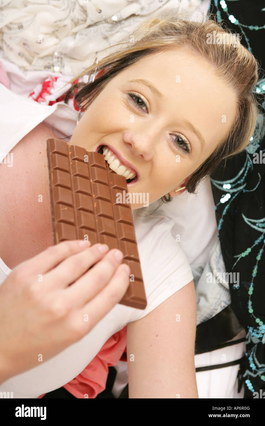 two young teen girls eating big bars of chocolate Stock Photo - Alamy